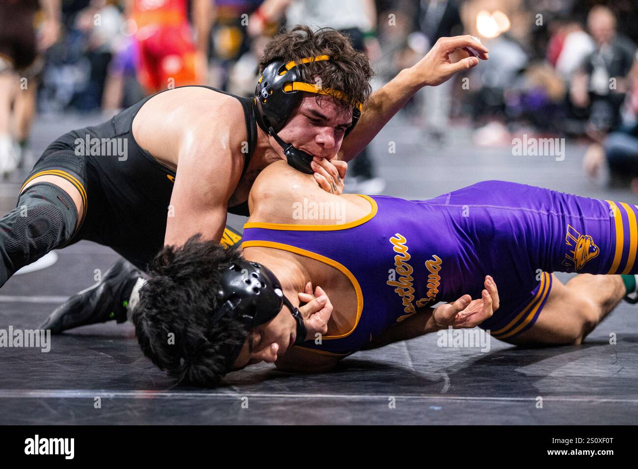 Iowa's Joey Cruz wrestles Northern Iowa's Brandon Paez at 125 pounds ...