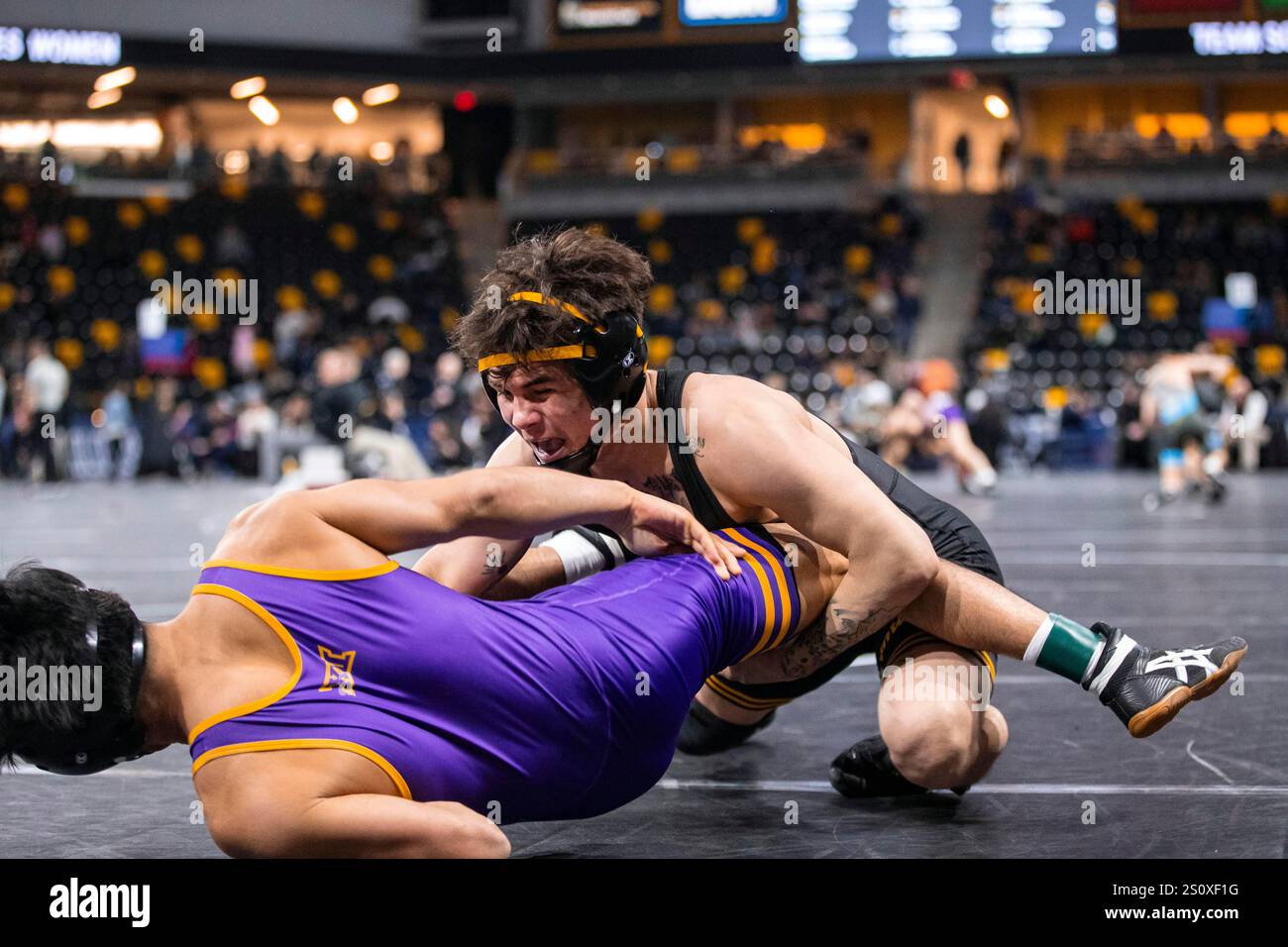 Iowa's Joey Cruz wrestles Northern Iowa's Brandon Paez at 125 pounds ...