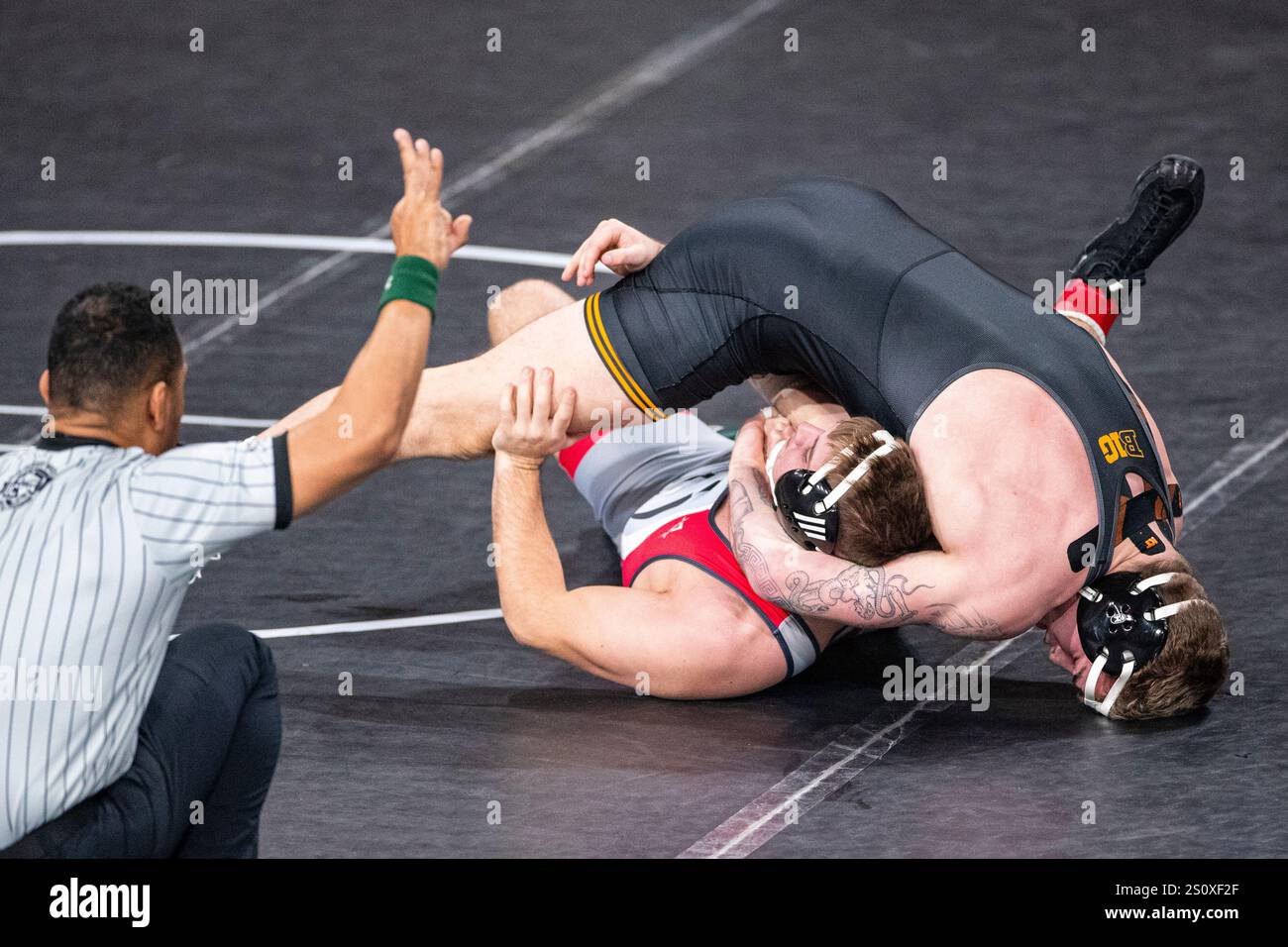 Iowa's Ben Kueter wrestles Bellarmine's Thad Huff at 285 pounds during ...