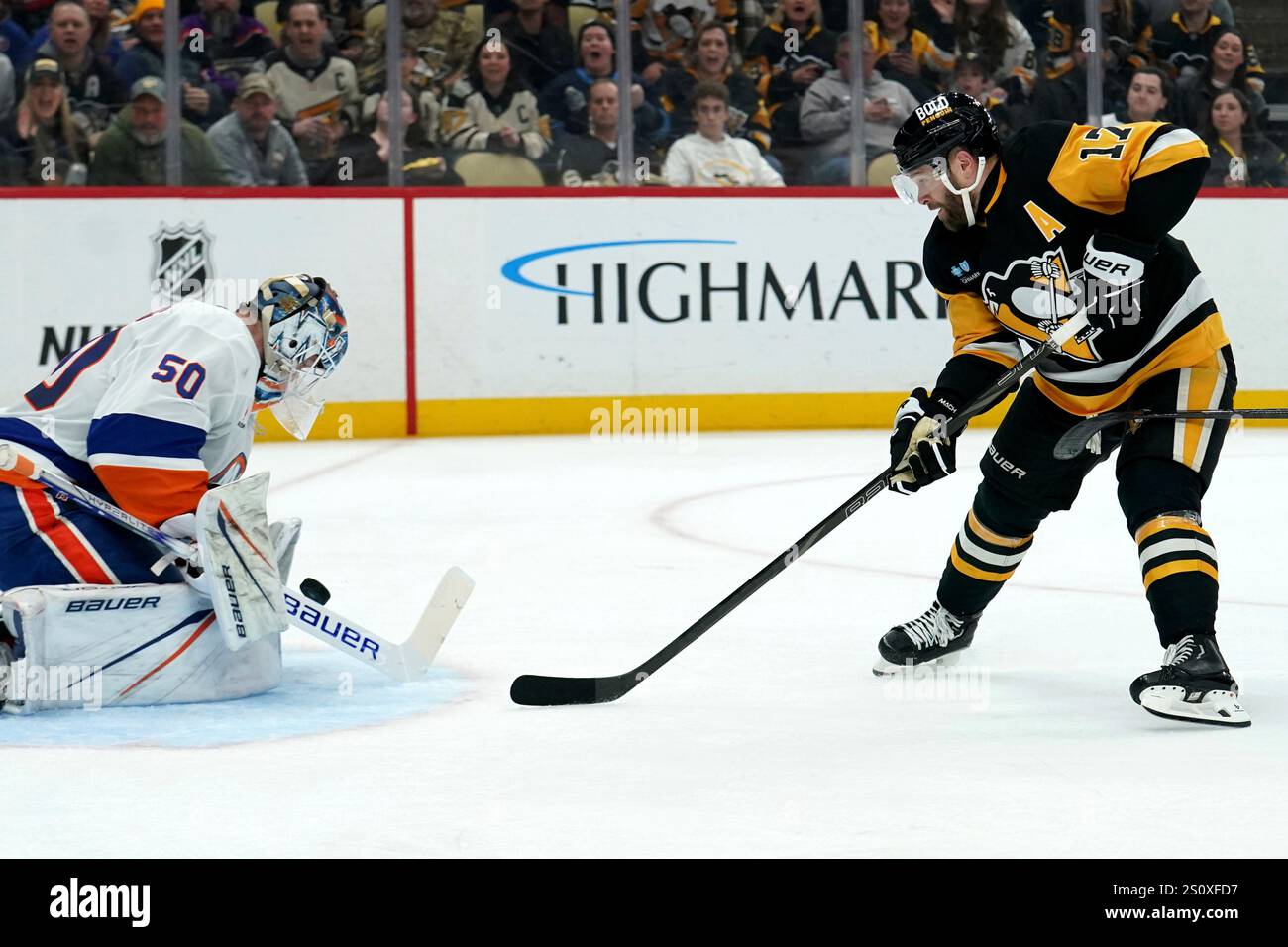 New York Islanders goaltender Marcus Hogberg (50) makes a save against ...