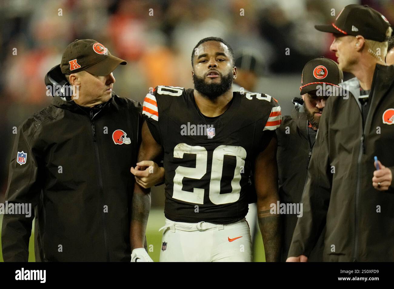 Cleveland Browns running back Pierre Strong Jr. (20) is led off the ...