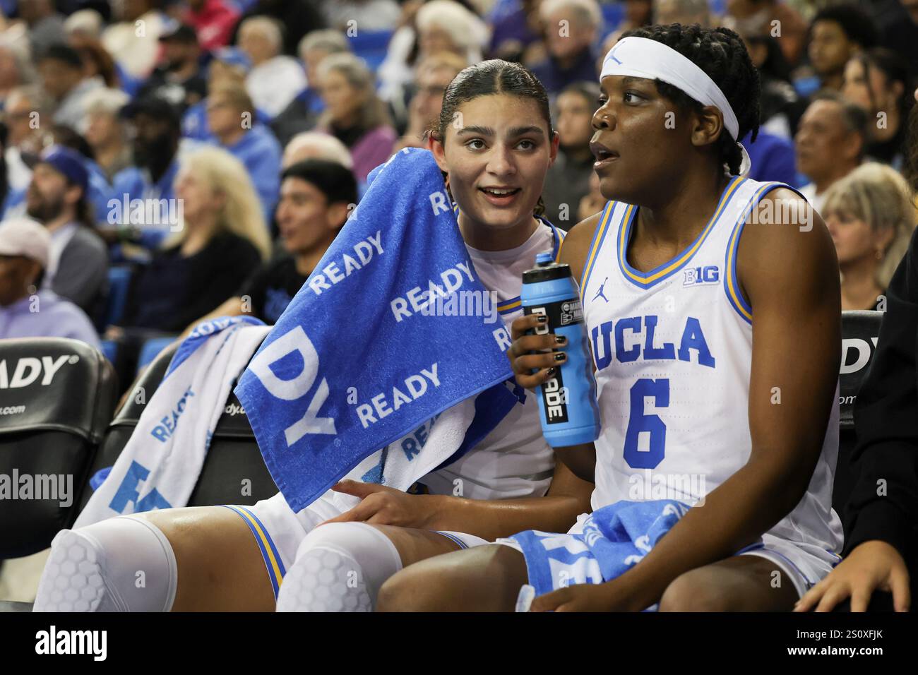 UCLA center Lauren Betts, left, speaks with forward Zania Socka-Nguemen ...