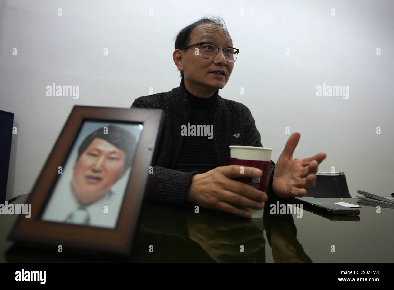 Kim Jeong-sam speaks during an interview next to his brother Kim Jung ...
