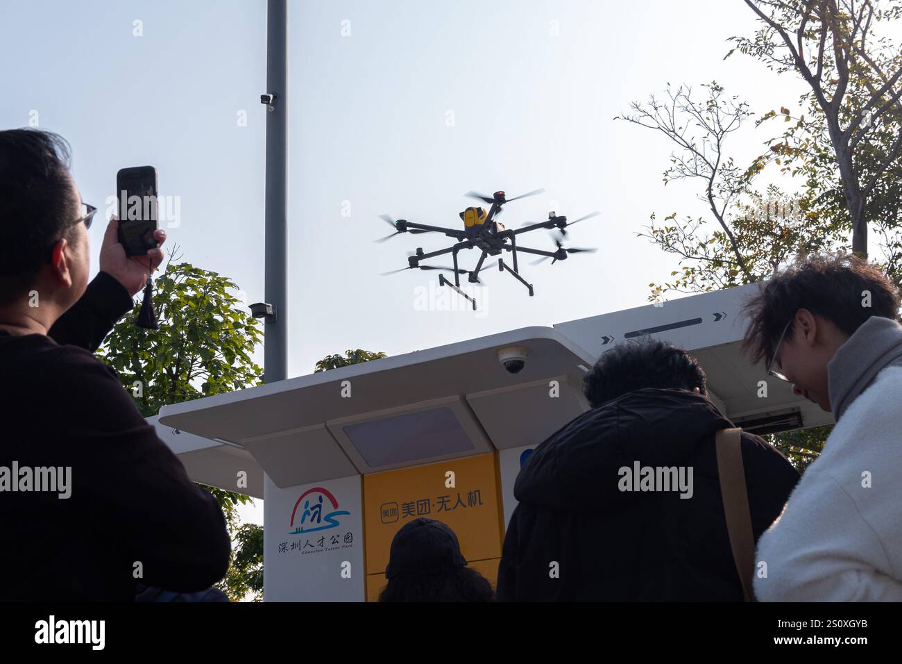 Shenzhen, China. 29th Dec, 2024. A Meituan drone delivers food to ...