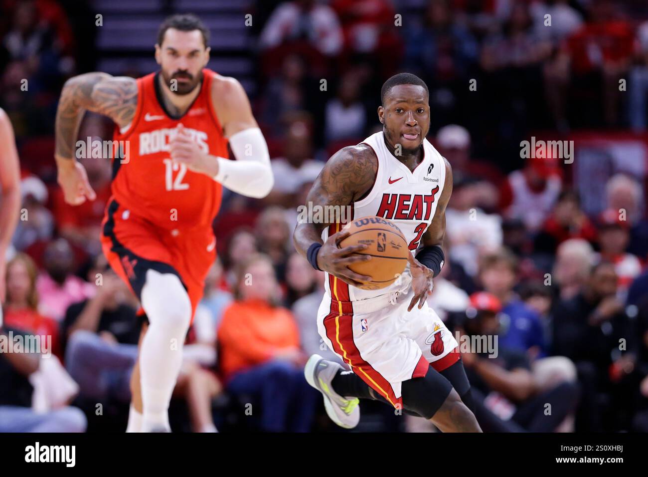 Miami Heat guard Terry Rozier III, right, drives down court in front of ...