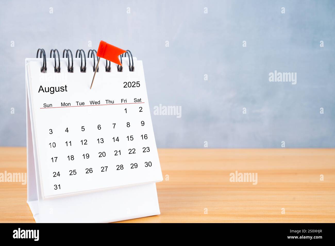 August 2025 calendar and red push pin on wooden table Stock Photo - Alamy