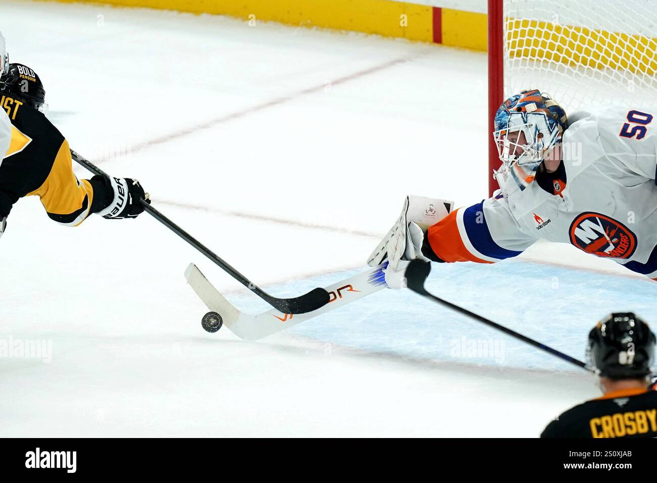 New York Islanders' goaltender Marcus Hogberg (50) makes a save against ...