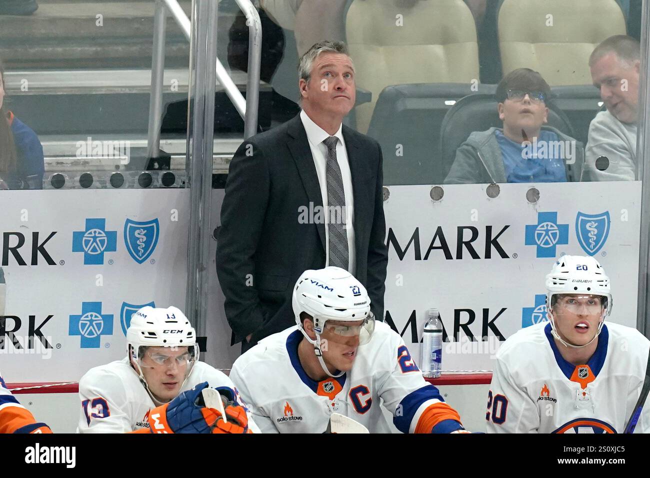 New York Islanders head coach Patrick Roy watches from behind his bench ...