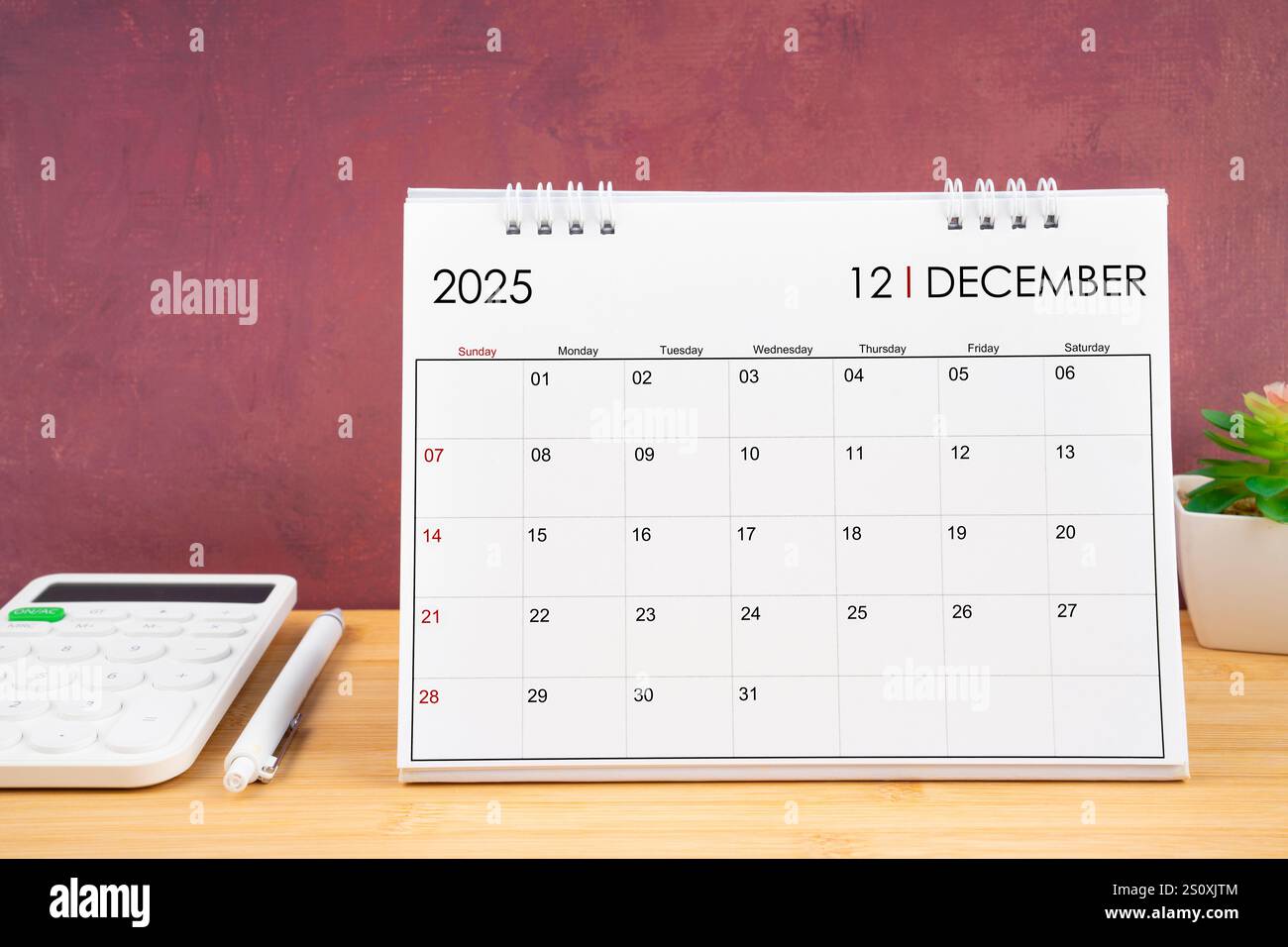 December 2025 white calendar and calculator with pen on the table Stock ...