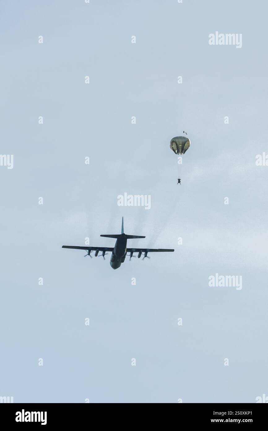 A member of the U.S. Army 11th Airborne Division parachute onto a ...