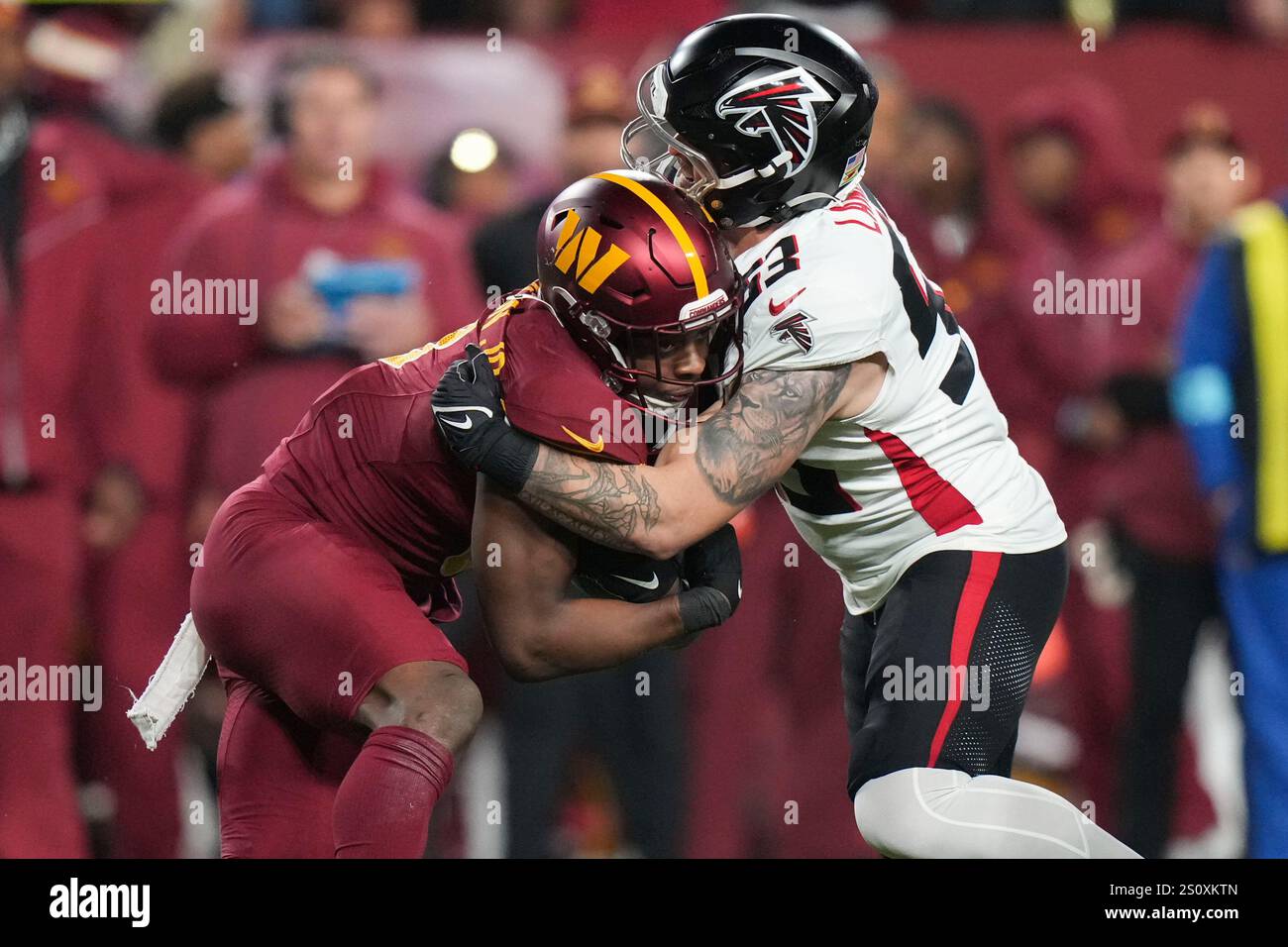Washington Commanders running back Brian Robinson Jr. (8) is tackled by ...