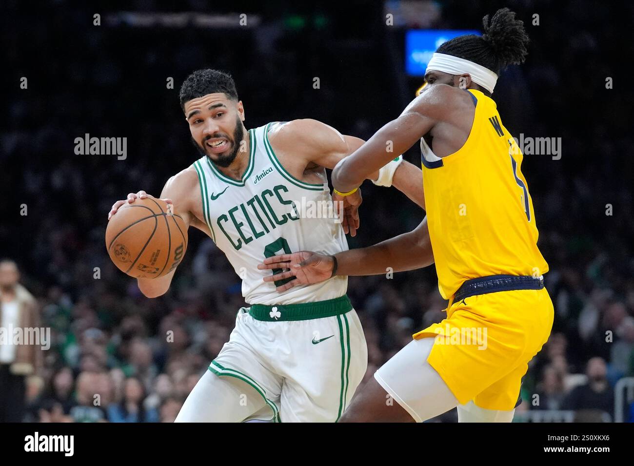 Boston Celtics forward Jayson Tatum, left, drives past Indiana Pacers ...