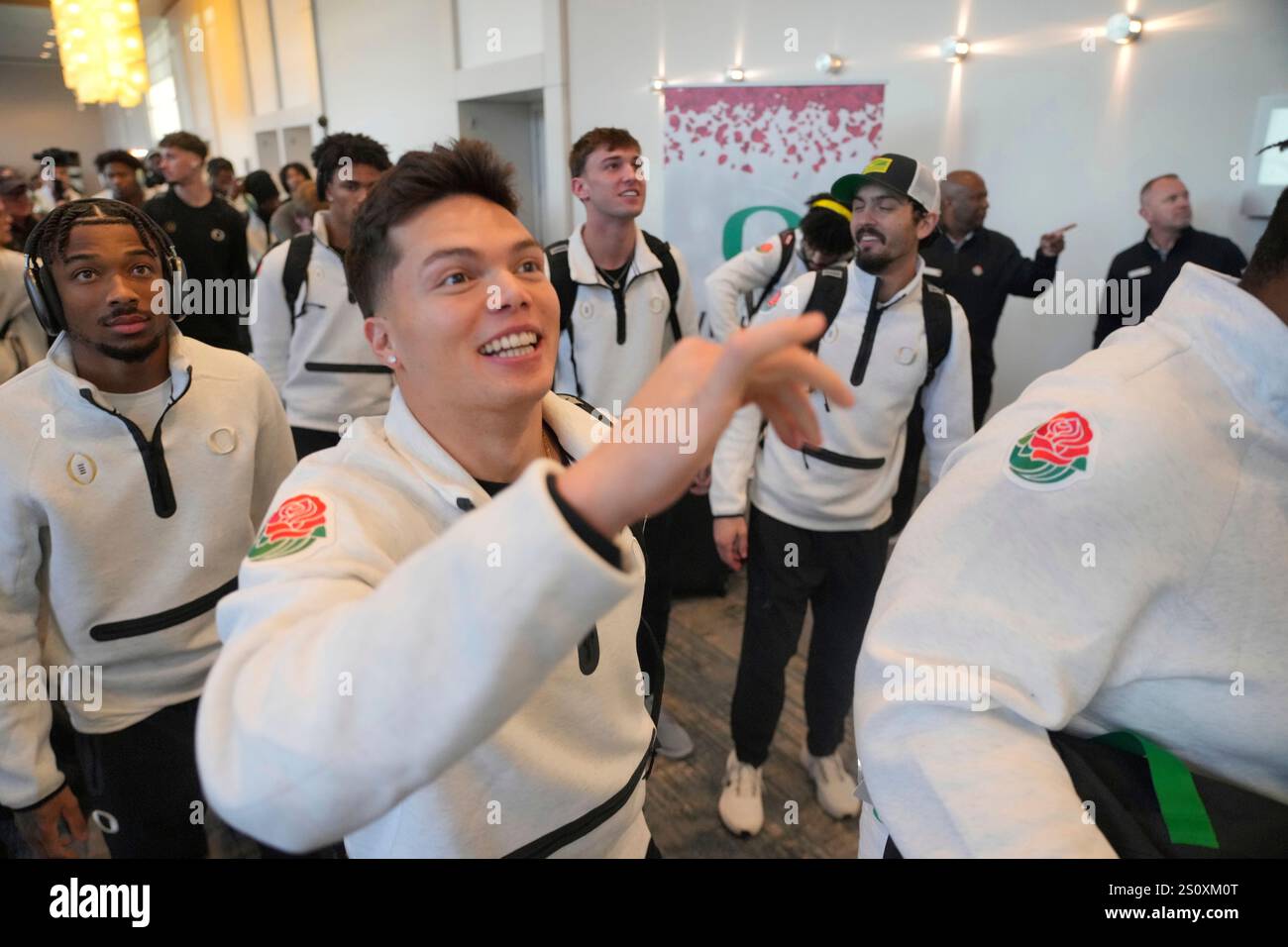 Oregon quarterback Dillon Gabriel, front center, smiles as he arrives ...
