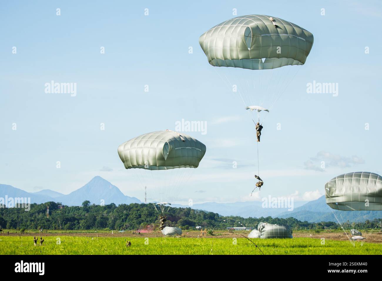 Members of the U.S. Army 11th Airborne Division parachute onto a ...