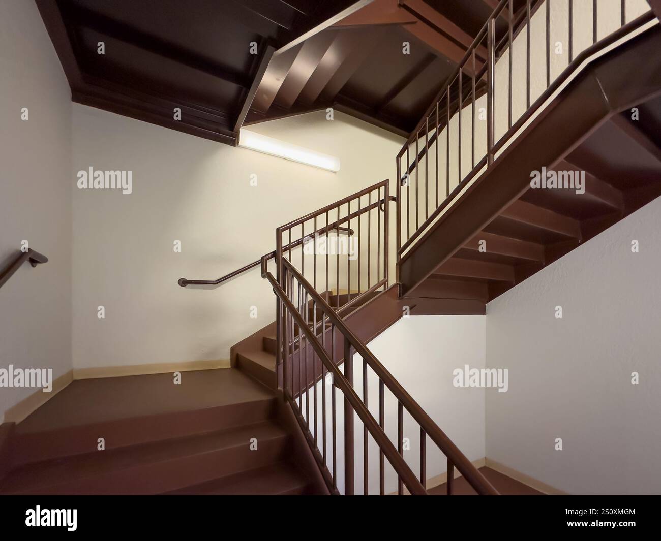 Close-up photo of a brown metal exit stairway, stair case, between ...