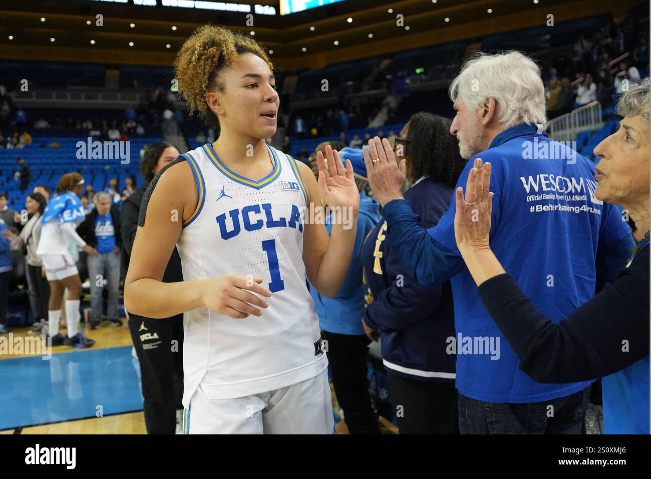UCLA Bruins guard Kiki Rice (1) is greeted by fans after a women's ...