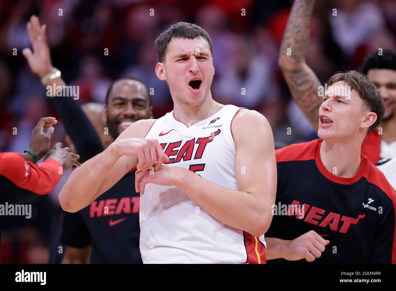Miami Heat forward Nikola Jovic, center, celebrates at the bench after ...