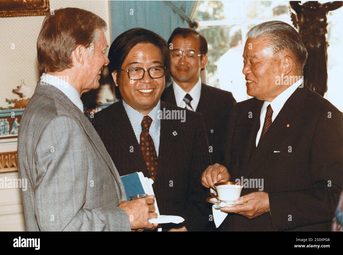 United States President Jimmy Carter, left, enjoys tea in the Blue Room ...