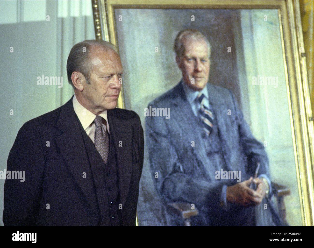 Former United States President Gerald R. Ford poses next to a painting ...