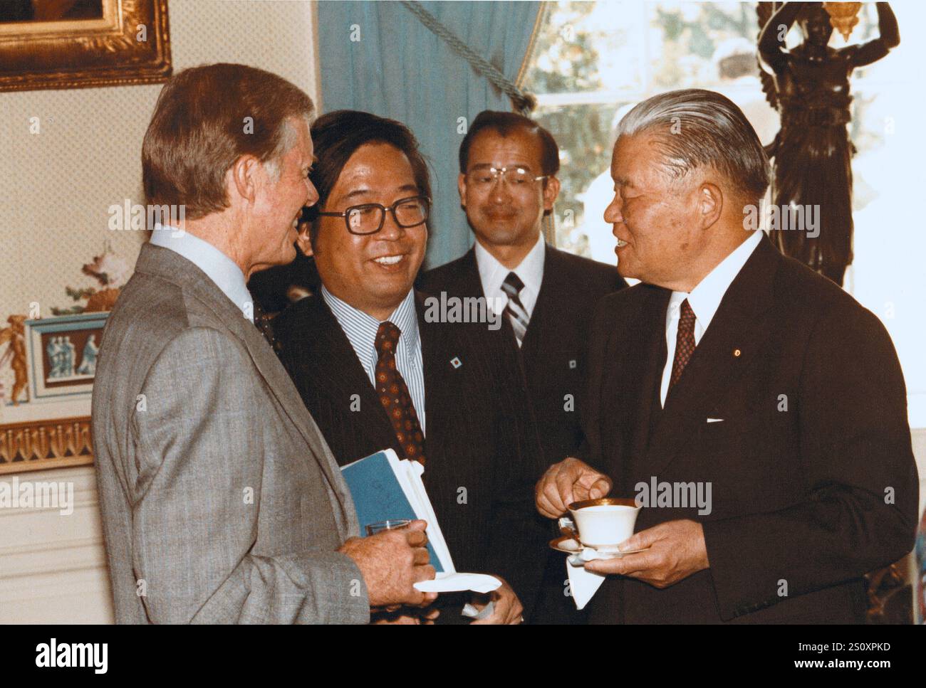 United States President Jimmy Carter, left, enjoys tea in the Blue Room ...