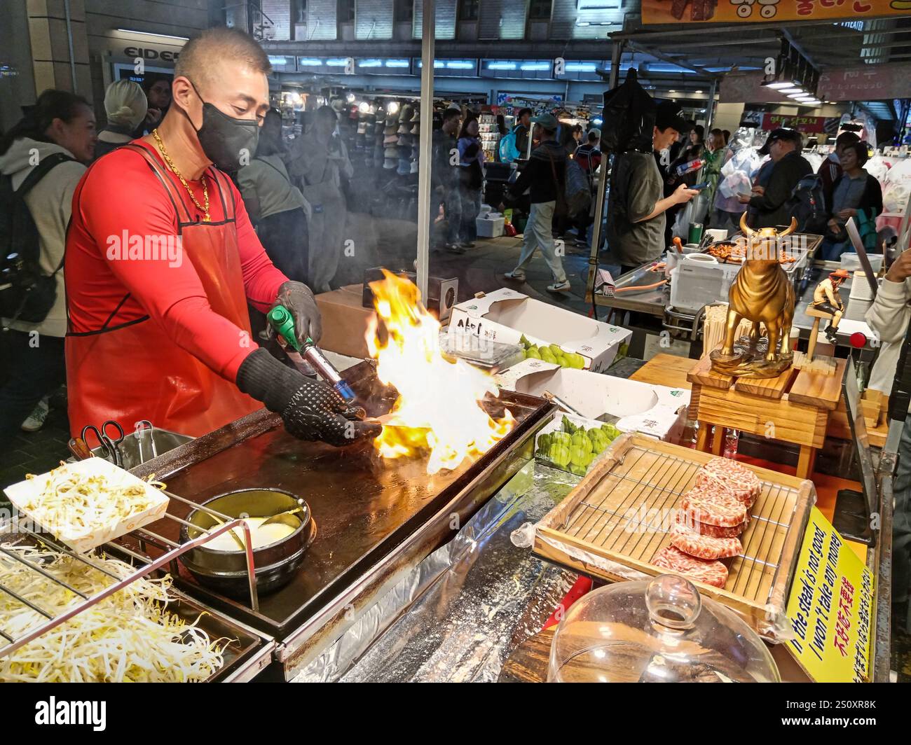Seoul, South Korea - October 28, 2024: Street scene of man cooking ...