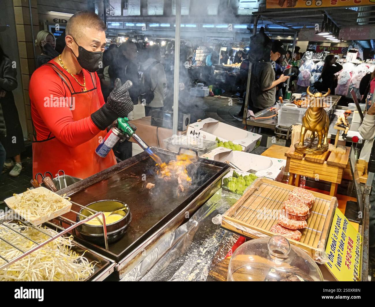 Seoul, South Korea - October 28, 2024: Street scene of man cooking ...