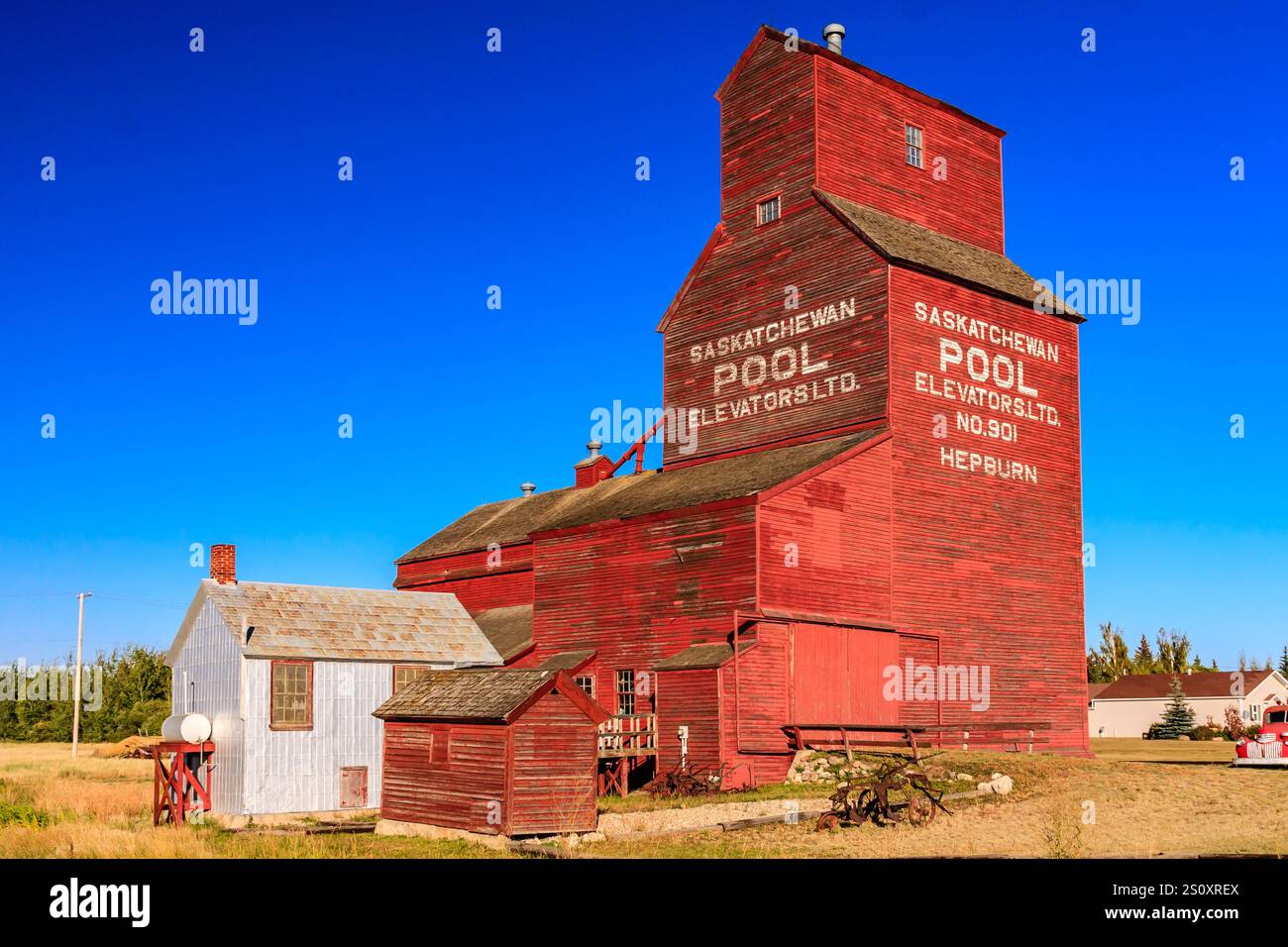 A red grain silo with a white sign that says Pool. The silo is ...