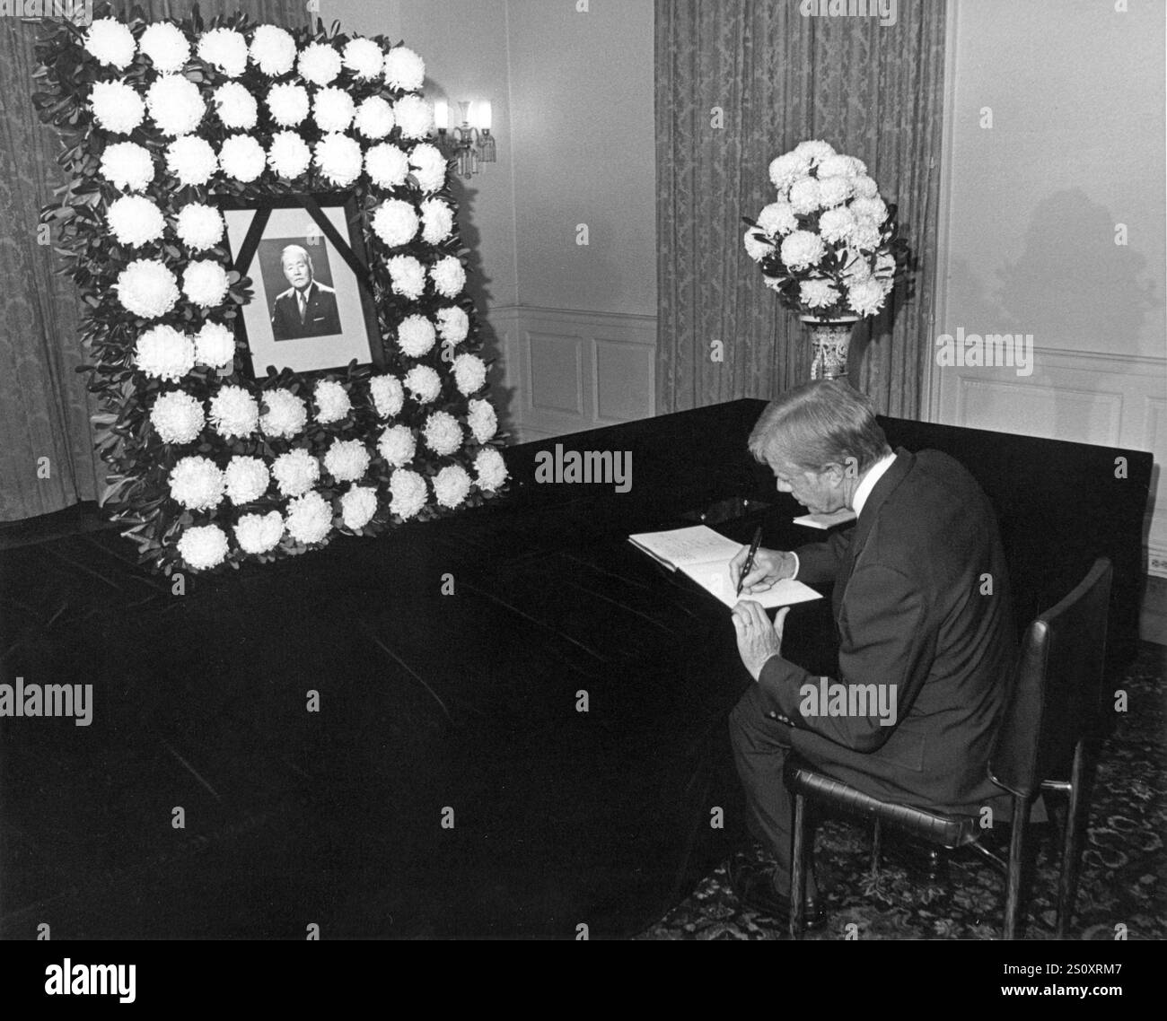 United States President Jimmy Carter signs a condolence book on the ...