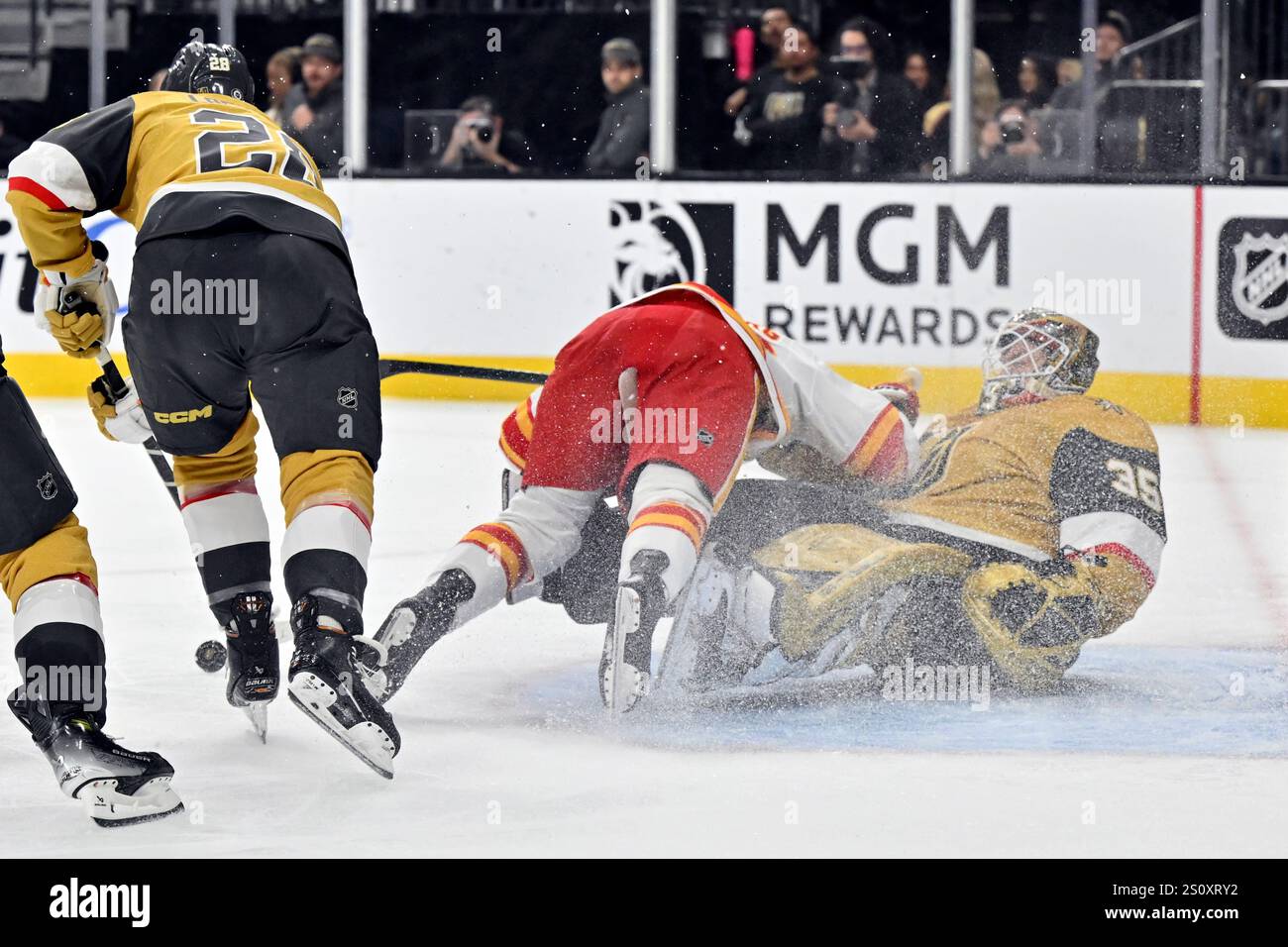 Calgary Flames left wing Ryan Lomberg, center, collides with Vegas ...