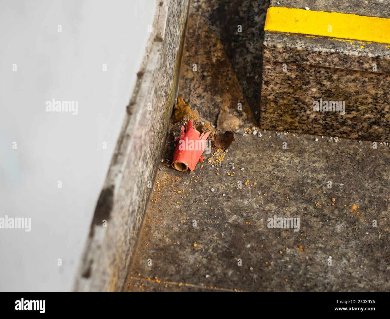 Red firecracker waste lying inside a building. Cardboard leftover with ...