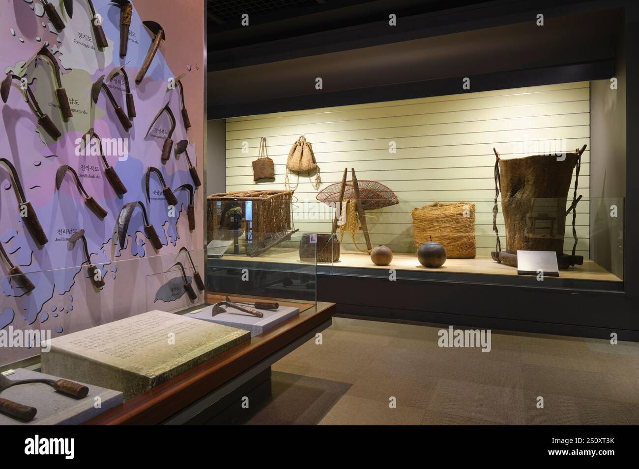 A gallery display of old, traditional village farming tools, including ...