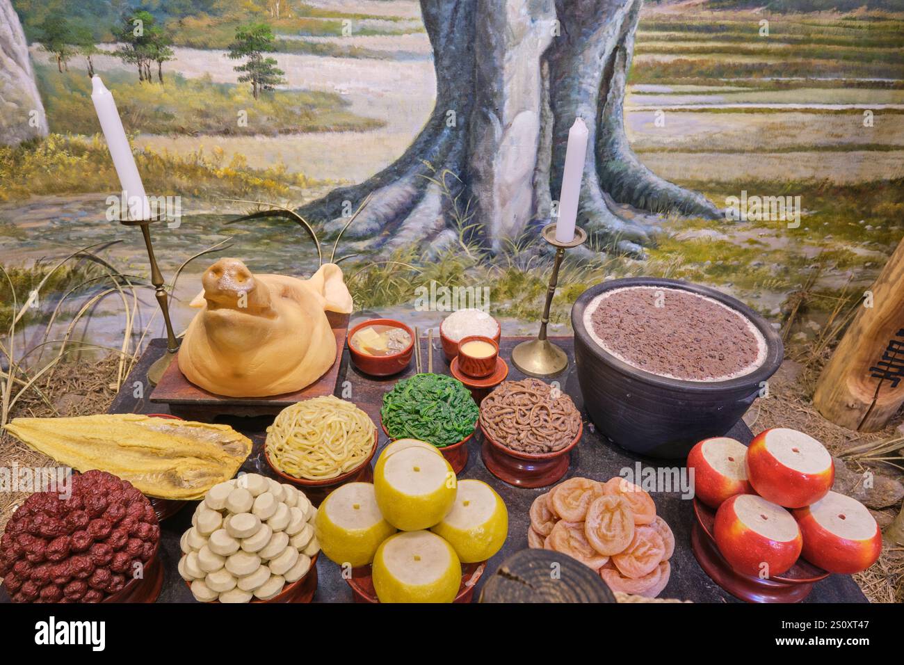 A typical feast, celebration meal in a field with fruit and a pig's ...