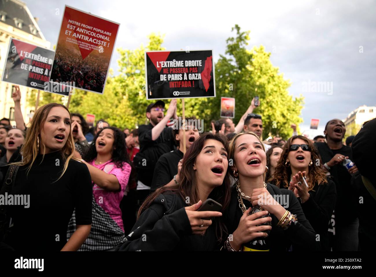 FILE - French voters react to the projected results of the second round ...