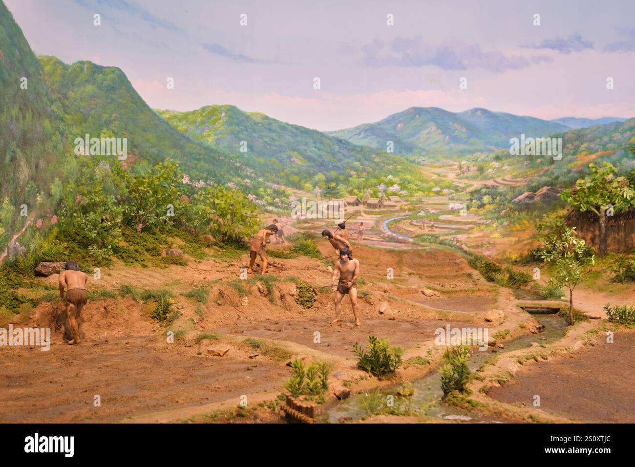 Village workers busy tending to rice paddies at a farm. A diorama at ...