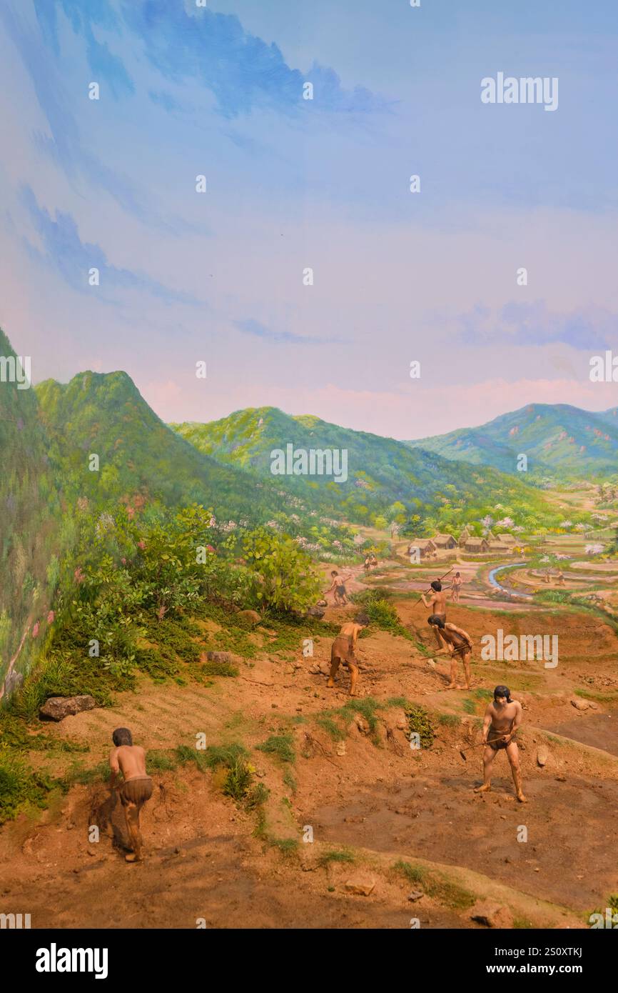 Village workers busy tending to rice paddies at a farm. A diorama at ...