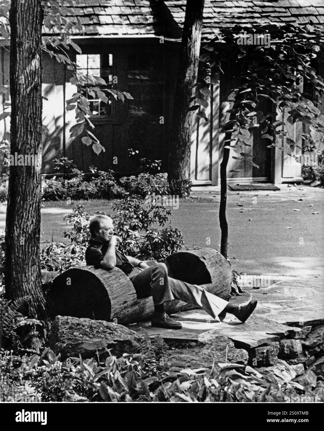 United States President Jimmy Carter relaxed in a cut-out log, which ...