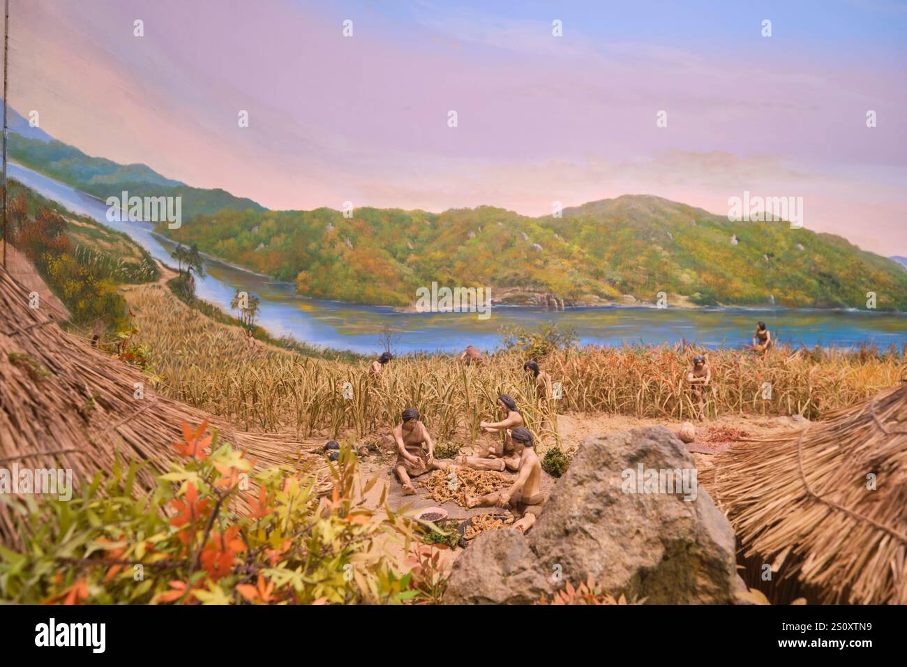 Villagers busy sorting, tending to the newly harvested crop of wheat ...