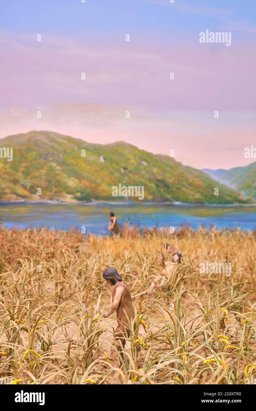 Villagers in a field, busy harvesting a wheat, millet crop. A diorama ...