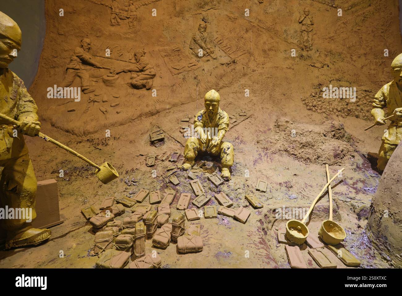 A worker busy smelting, making iron in a basic, village fire pit area ...