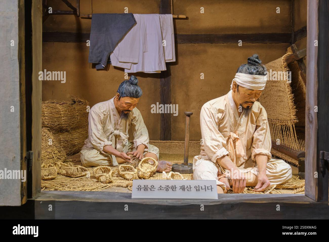 Workers busy weaving, making basic, simple shoes from rope, twine at ...