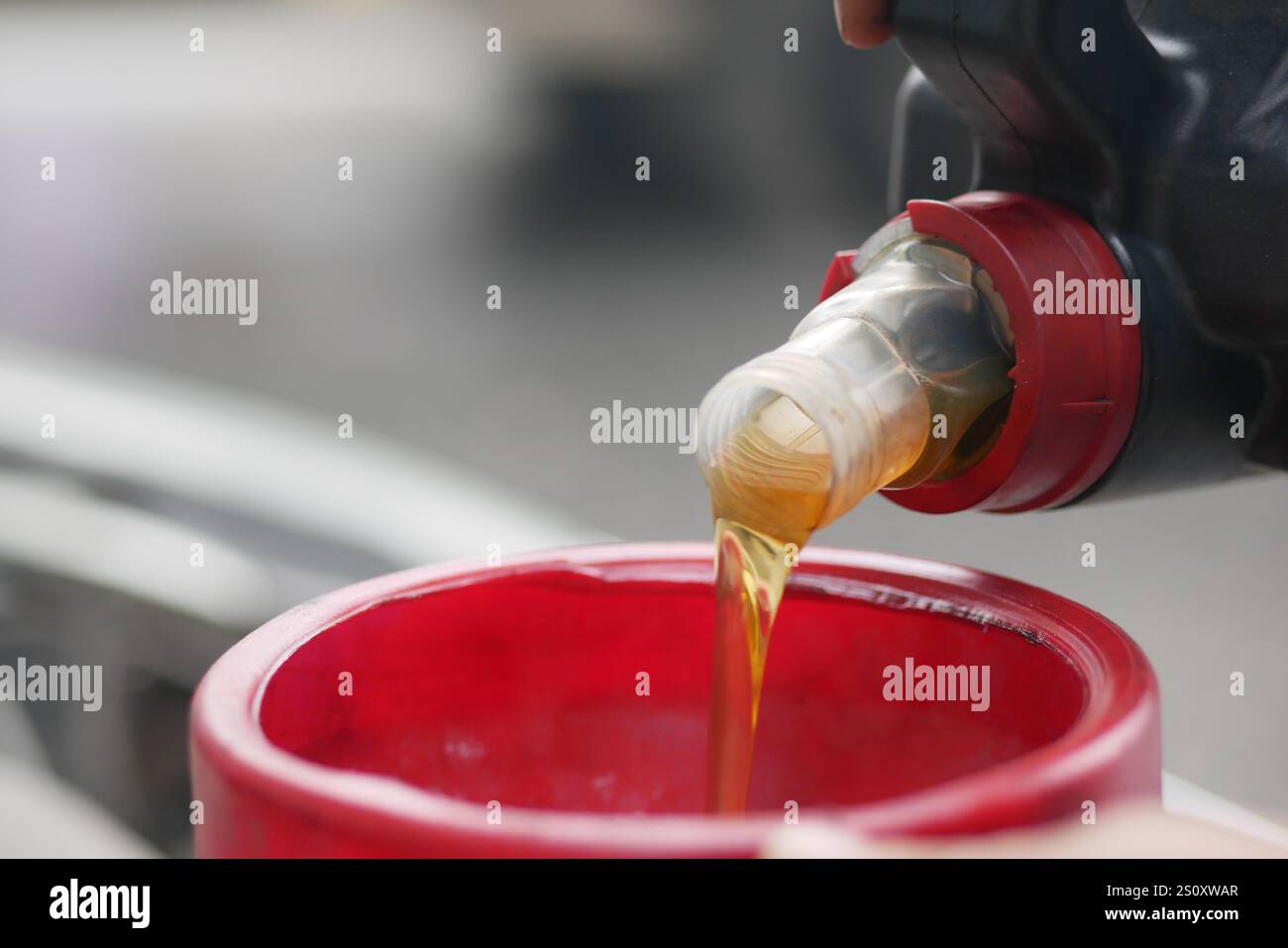 Pouring Liquid Into Red Funnel For Engine Maintenance Stock Photo - Alamy