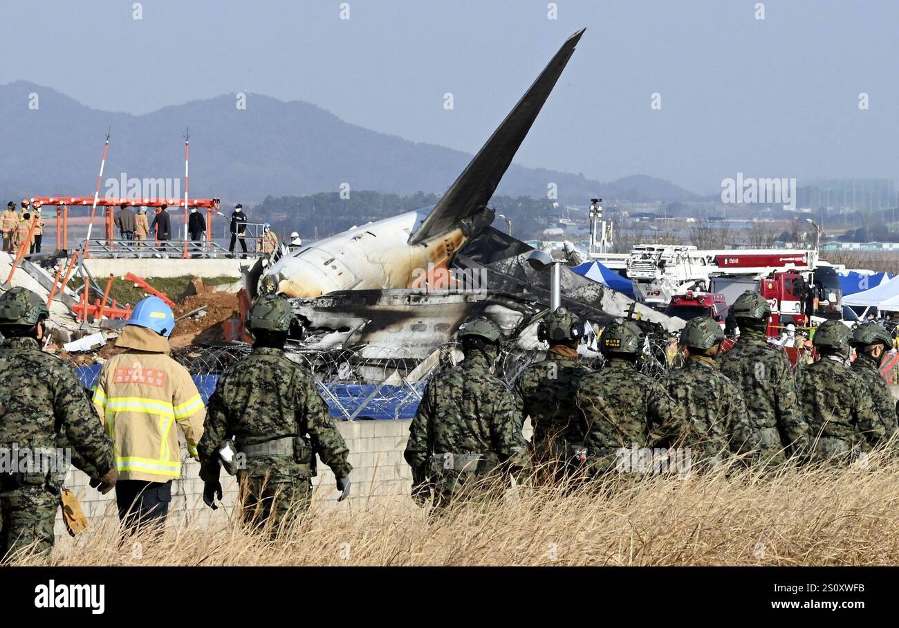 South Korean soldiers work near the wreckage of a passenger plane that ...