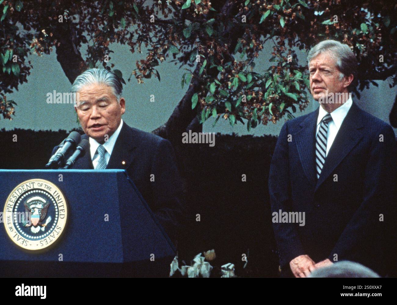 Prime Minister Masayoshi Ohira of Japan, left, makes remarks as he and ...