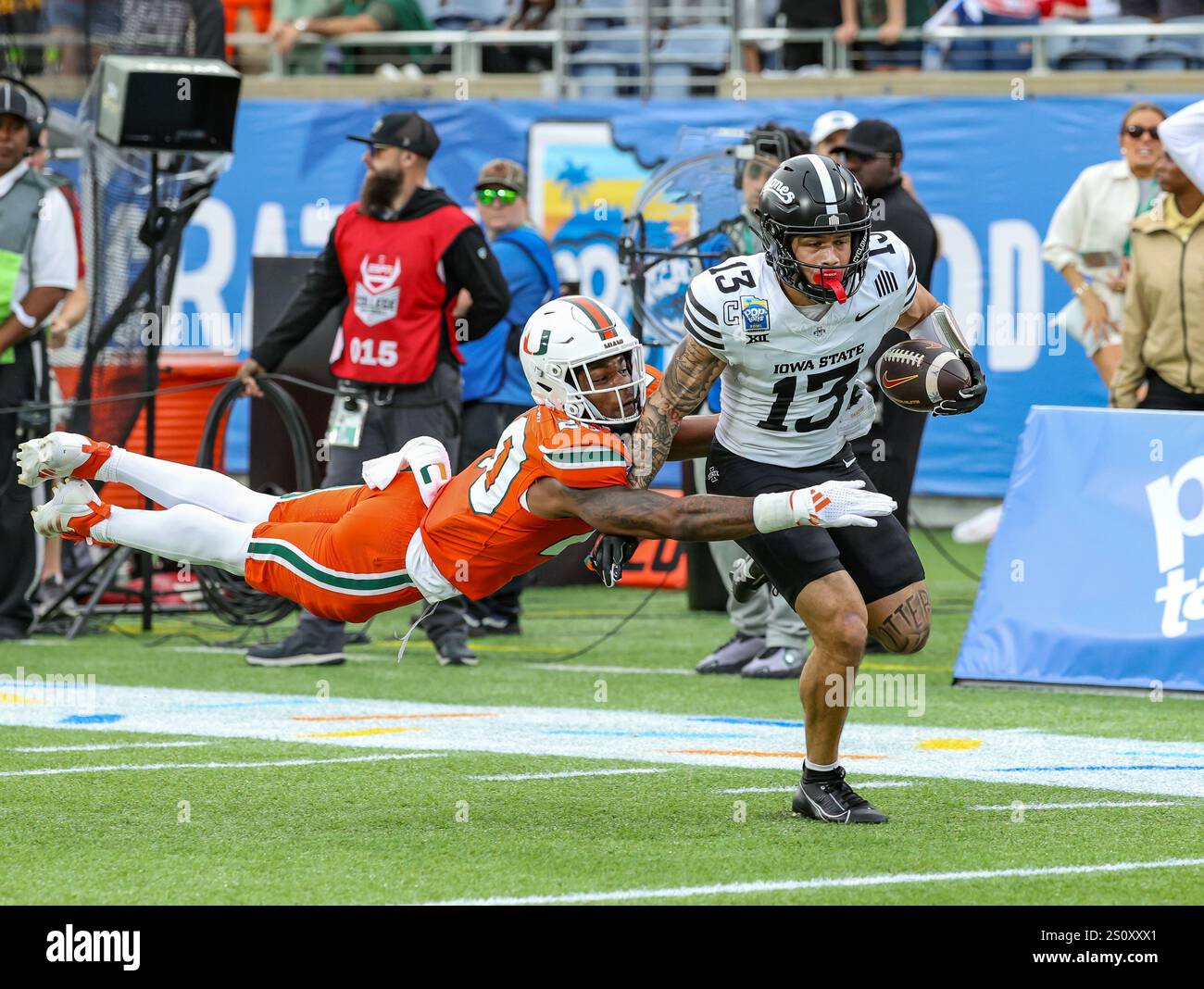 Orlando, FL, USA. 28th Dec, 2024. Miami's Zaquan Patterson (20) dives ...