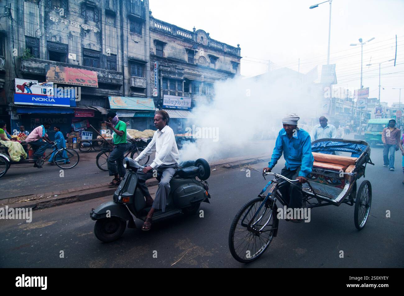 A pile of rubish burning in the middle of the street in Lucknow, India ...
