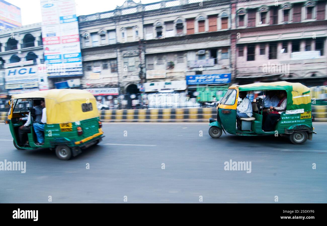 Auto rickshaws rushing through the old commercial centre in Lucknow ...