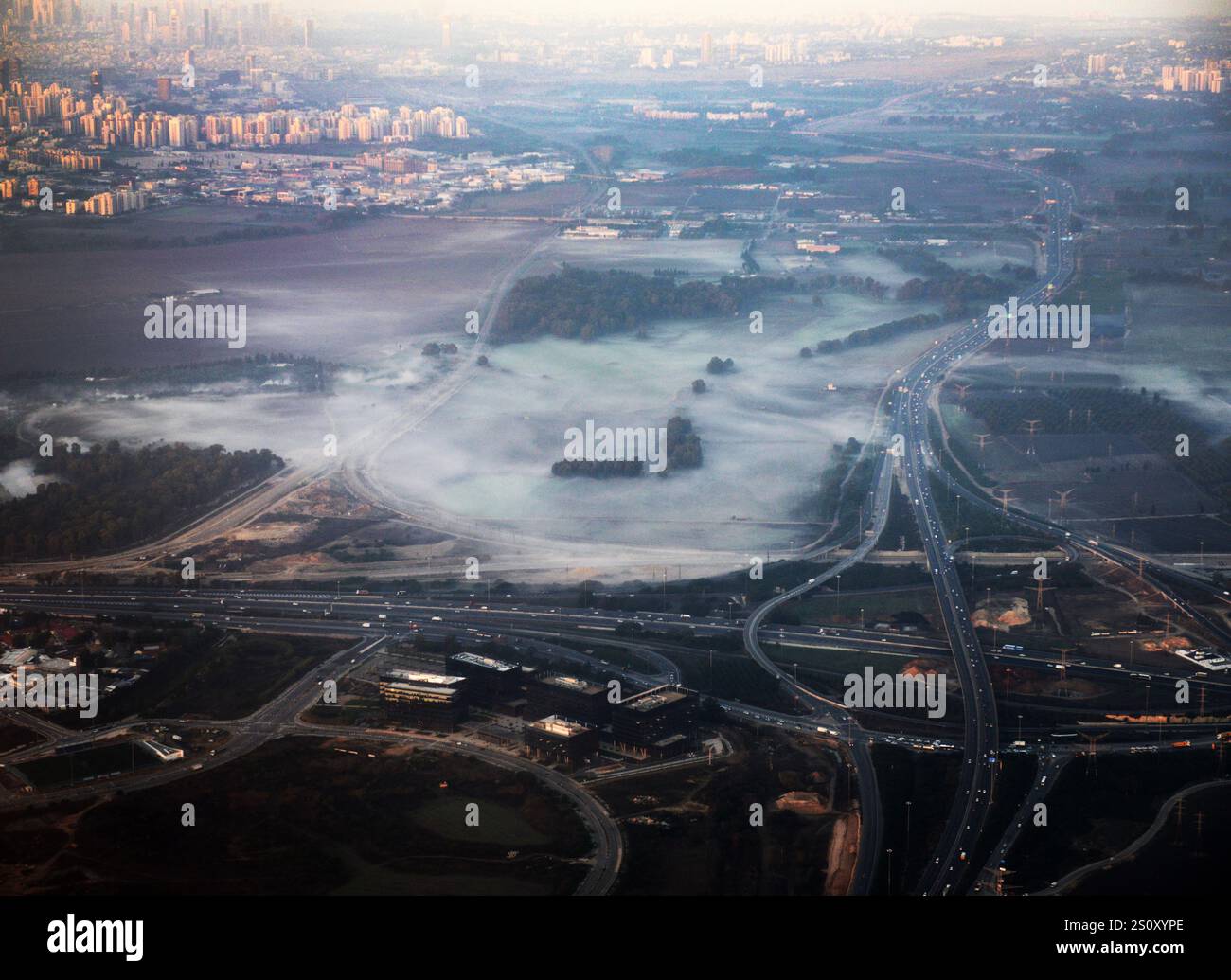 Aerial views of early morning mists over farmlands in the Sharon plain ...