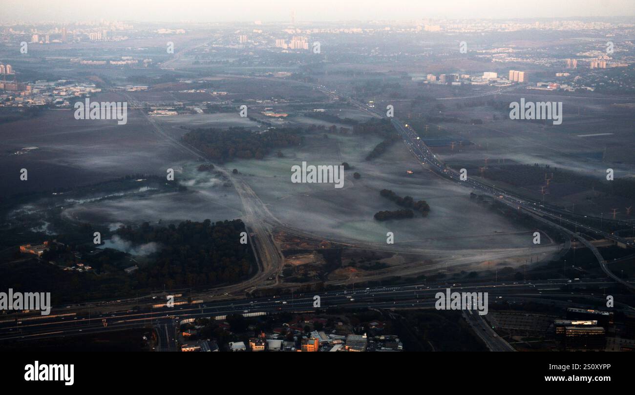 Aerial views of early morning mists over farmlands in the Sharon plain ...