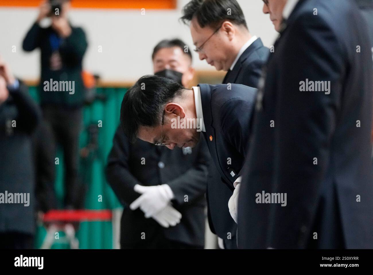 South Korea's acting President Choi Sang-mok bows for the victims on a plane which skidded off a ...