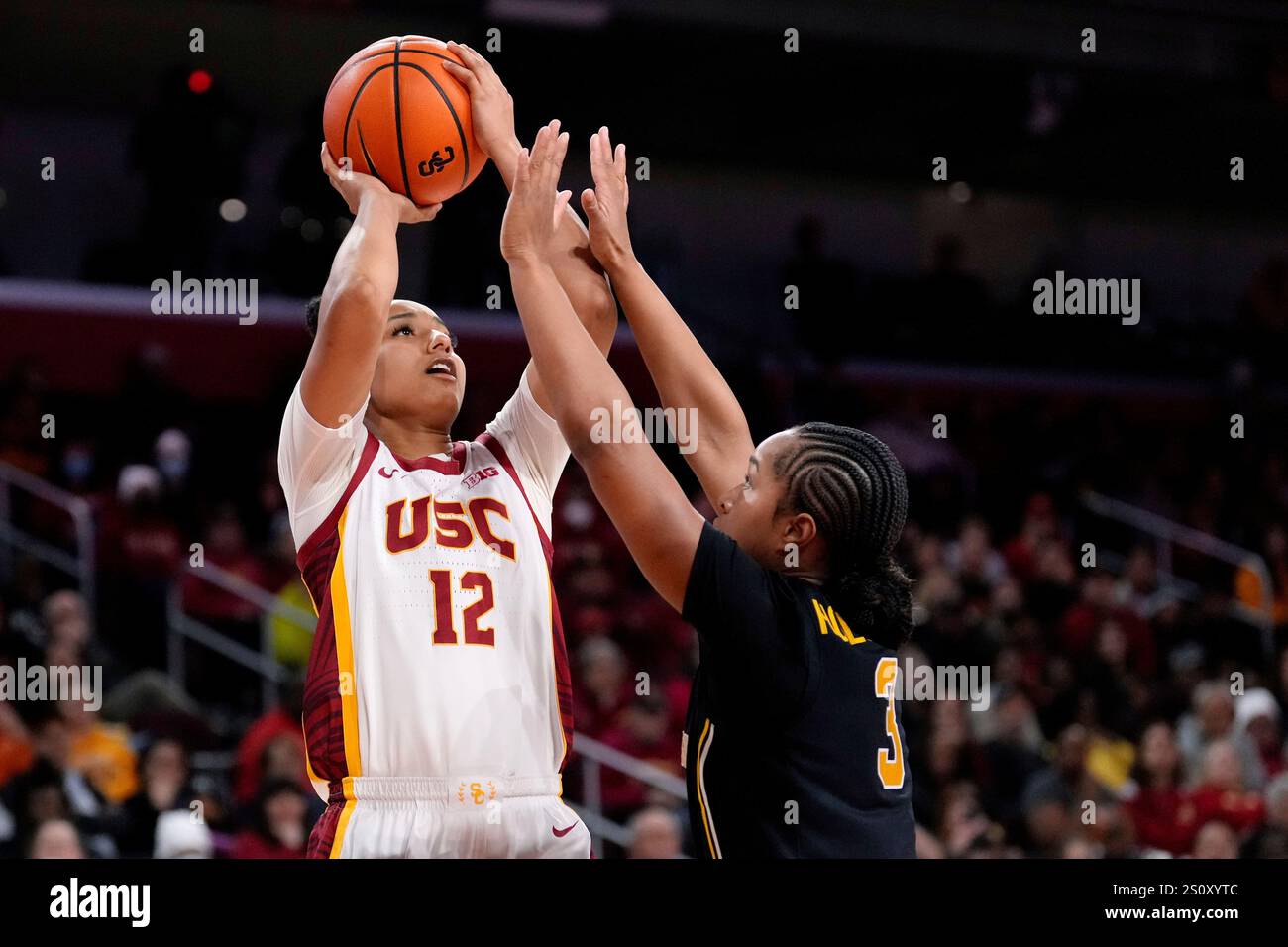 Southern California guard JuJu Watkins, left, shoots as Michigan guard ...